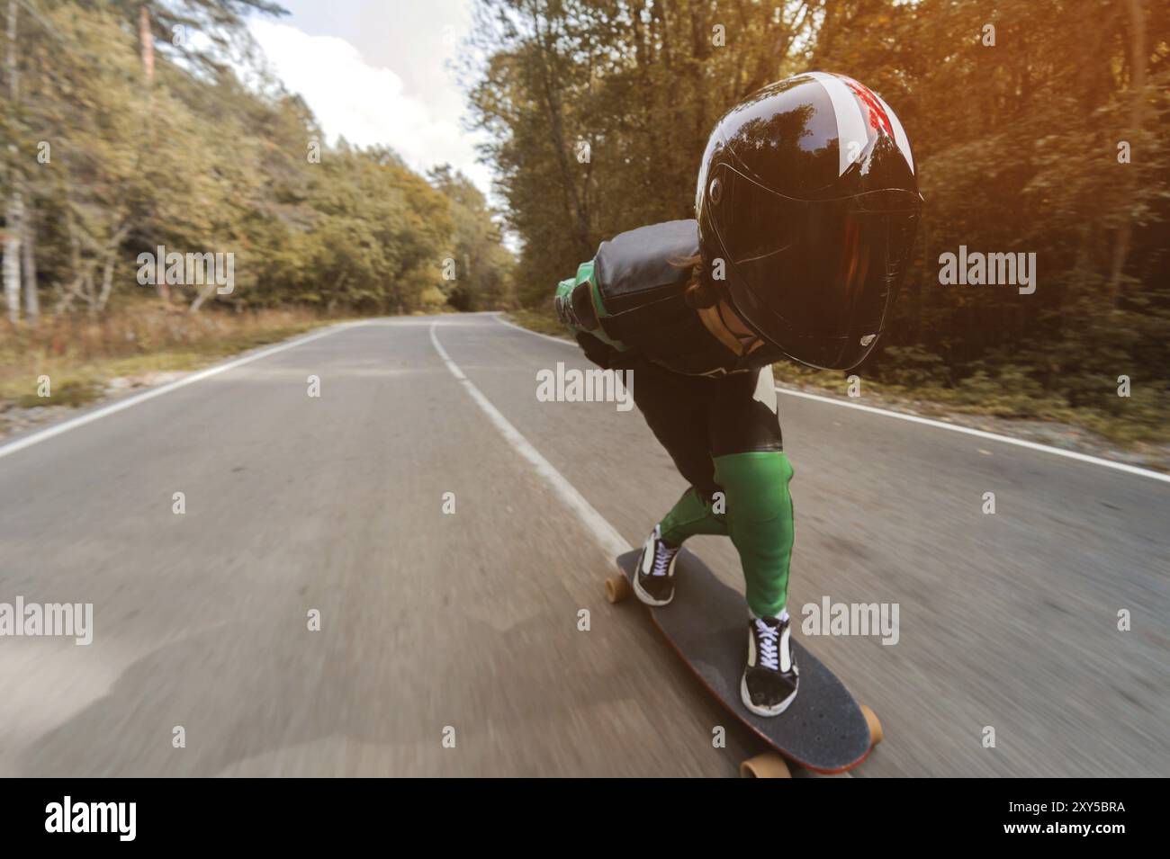 A young rider in a special leather suit and a full-length helmet is ...