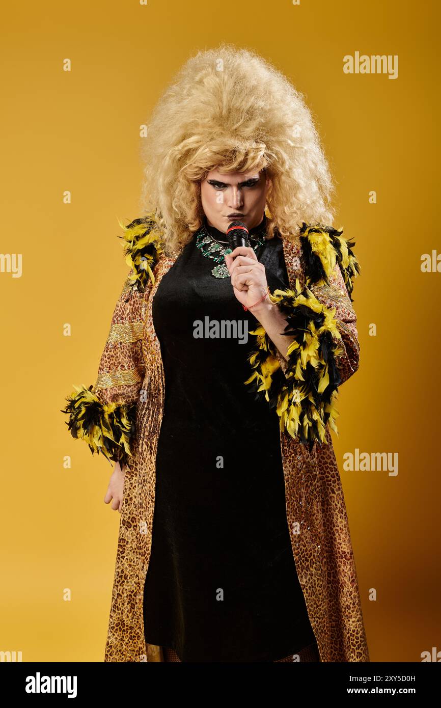 A drag queen in a leopard-print coat with yellow feathers sings into a ...