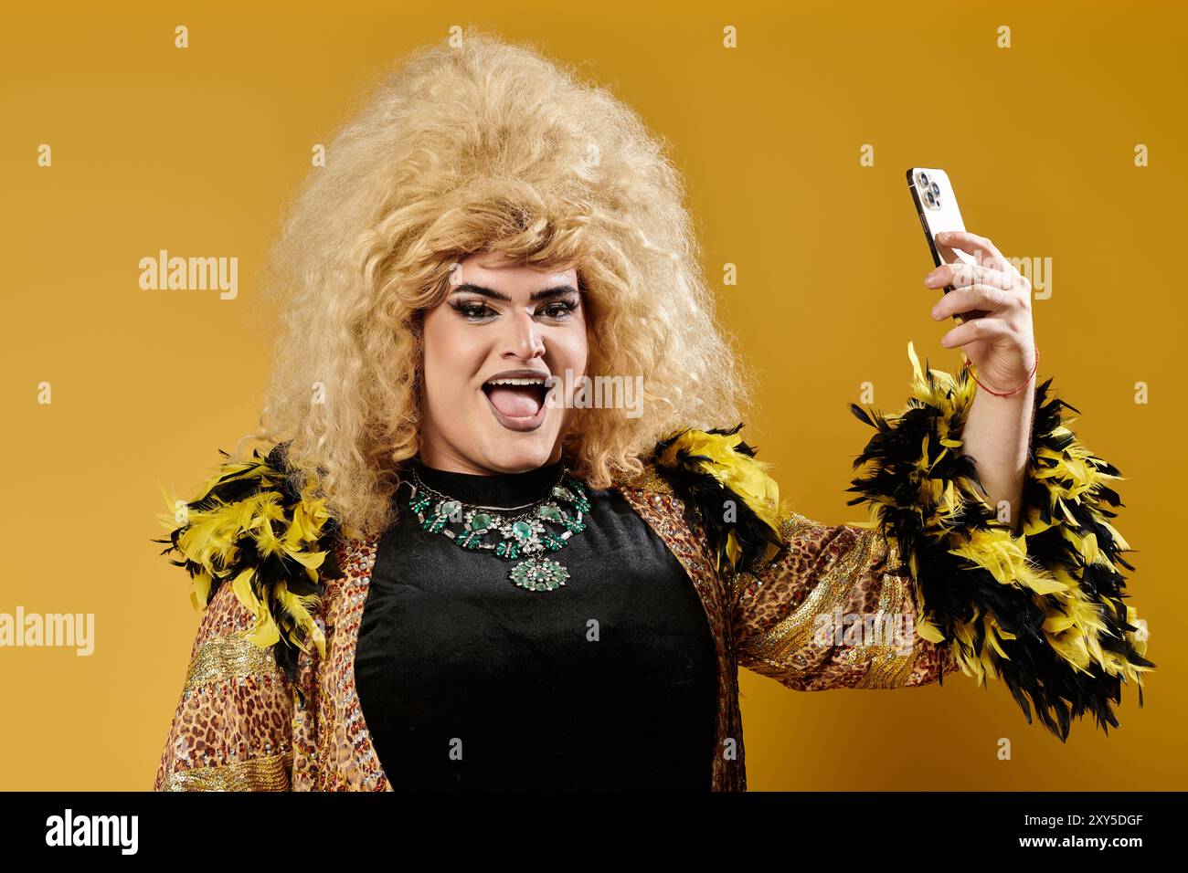 A drag queen in a stylish outfit poses for a selfie with a joyful ...