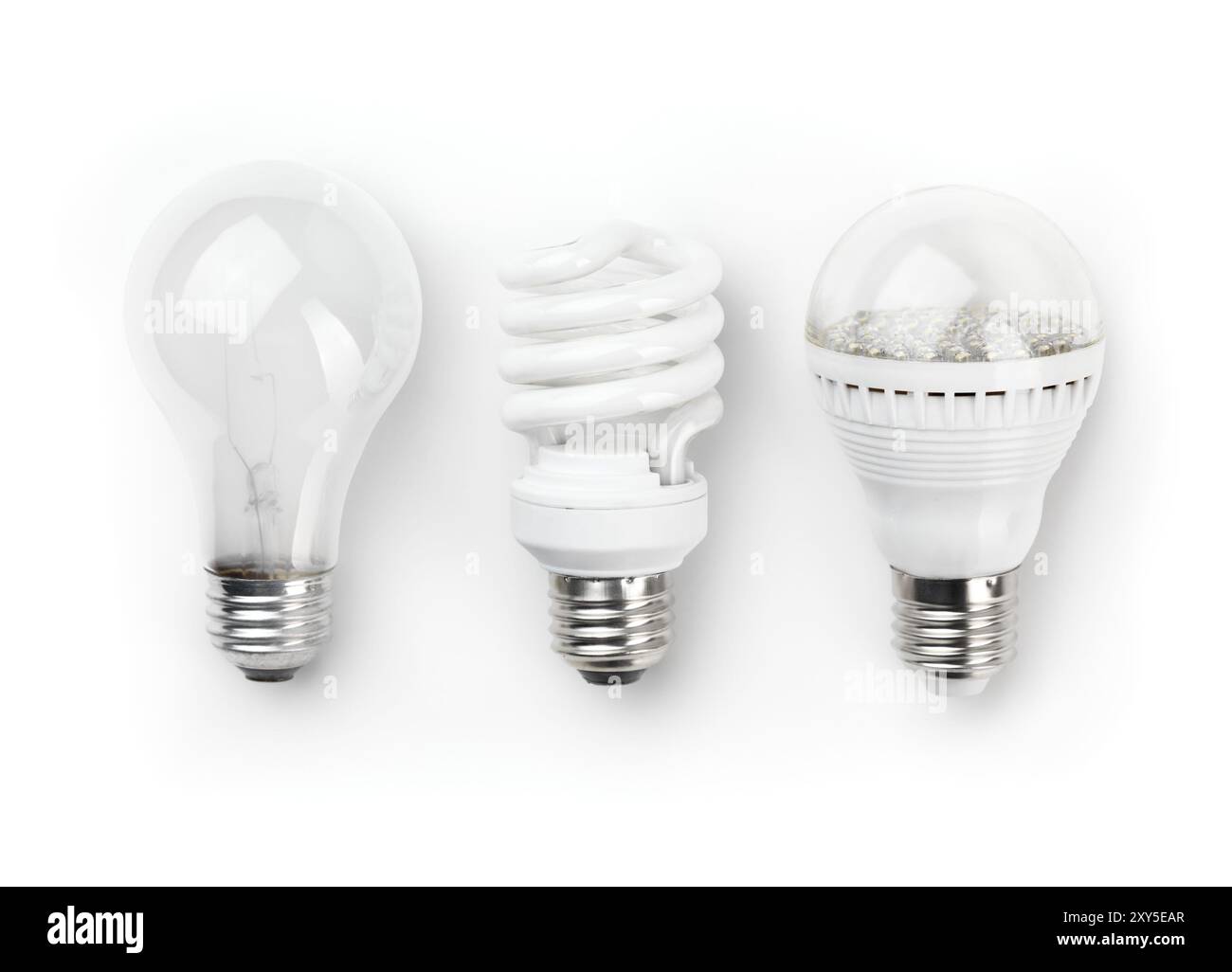Three generations of light bulbs. Regular incandescent, energy saving ...