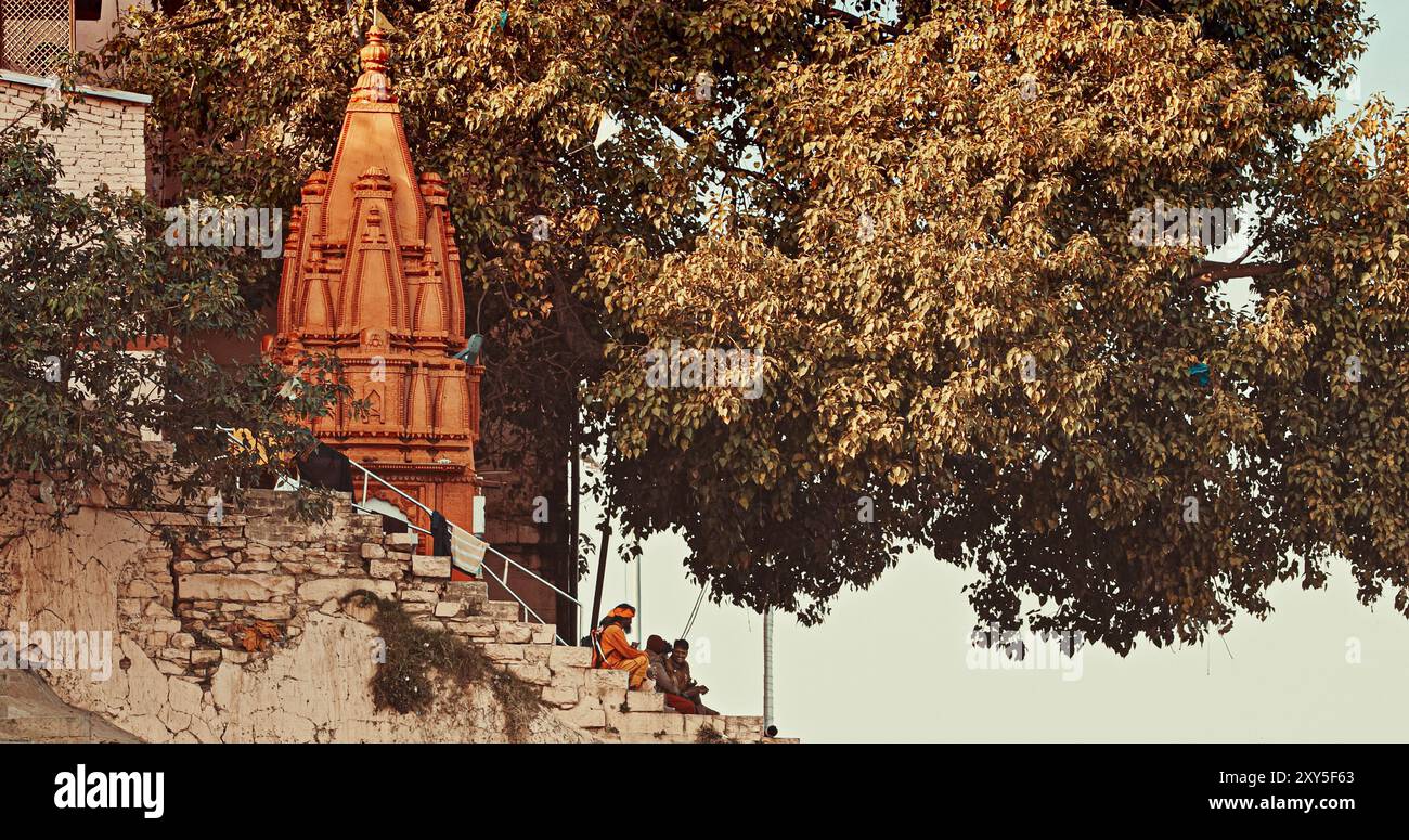 Varanasi, India. Tourists And Indian Pilgrims Sitting On Steps Of ...