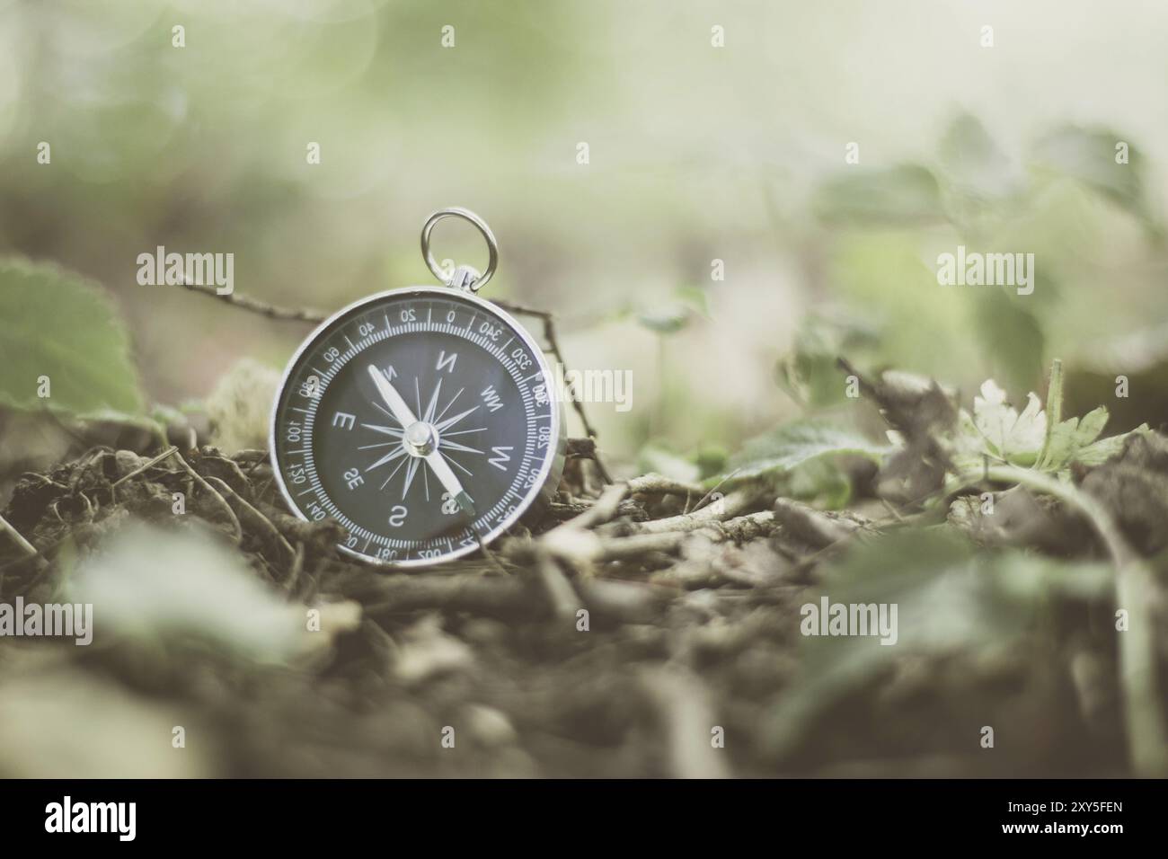 Vintage compass lying on the floor. Adventure and discovery concept ...