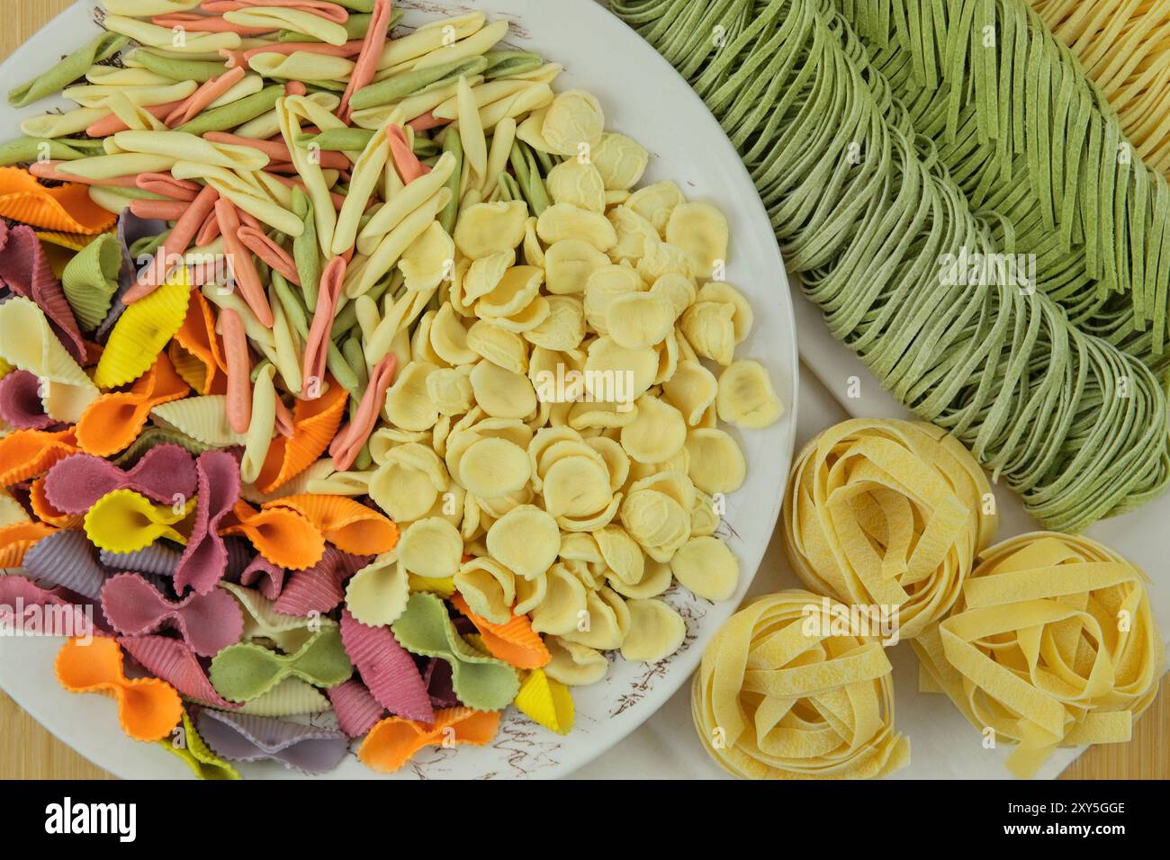 Varieties of multi-colored pasta. Types of uncooked pasta. Pattern of ...