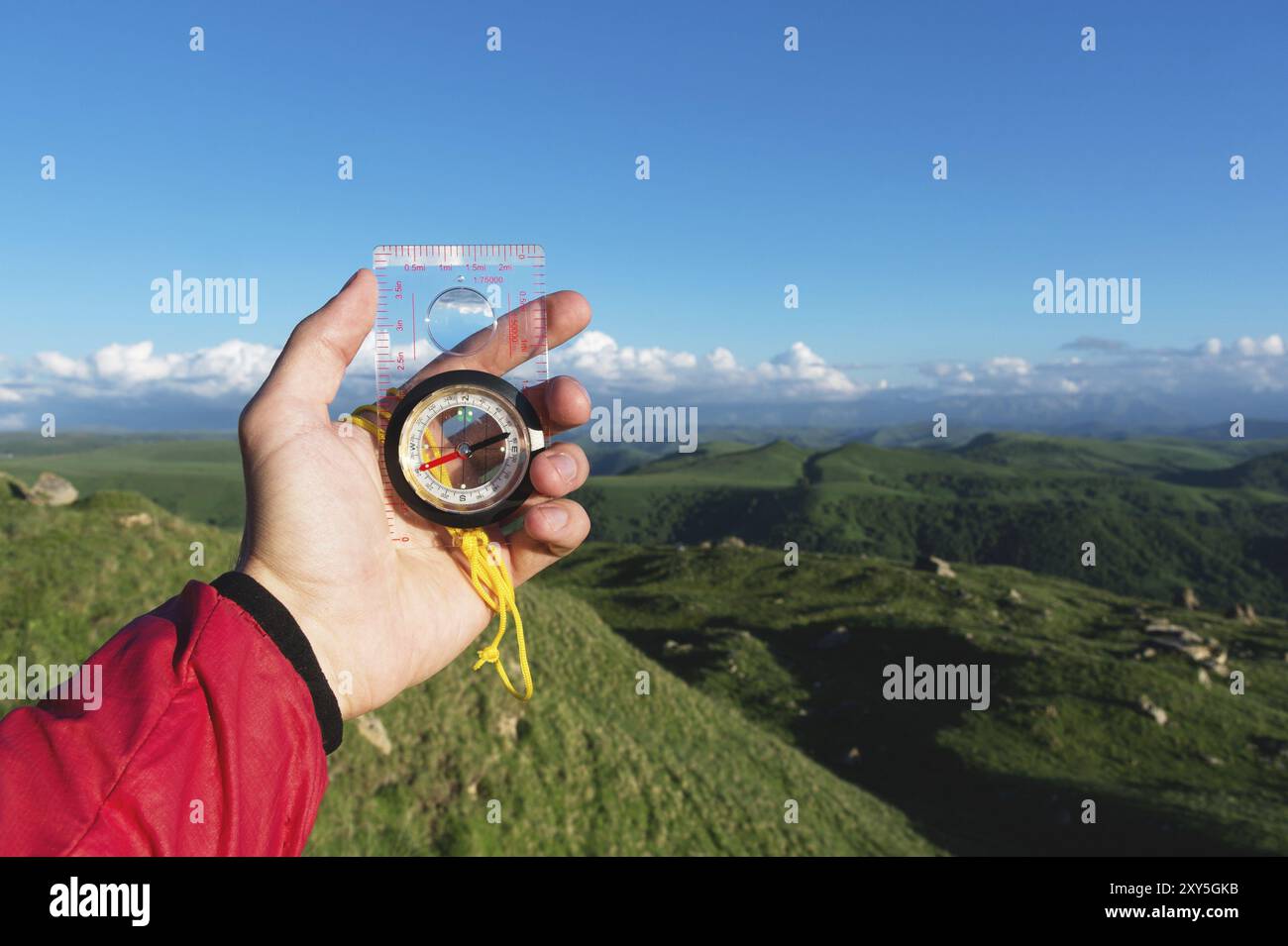 Man searching direction with a compass in his hand in the summer ...