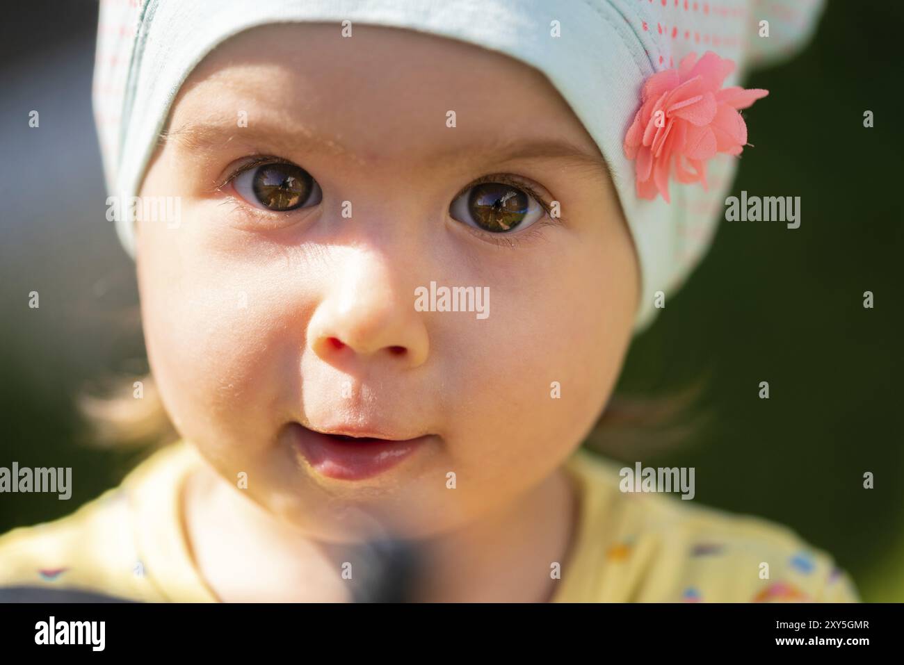 Portrait of very sweet little child with big eyes. 1 year old baby girl ...