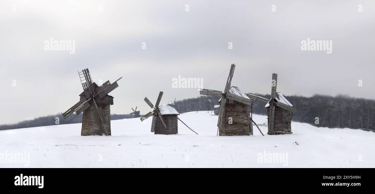Ancient wooden windmills in a snow covered field Ukraine Eastern Europe ...