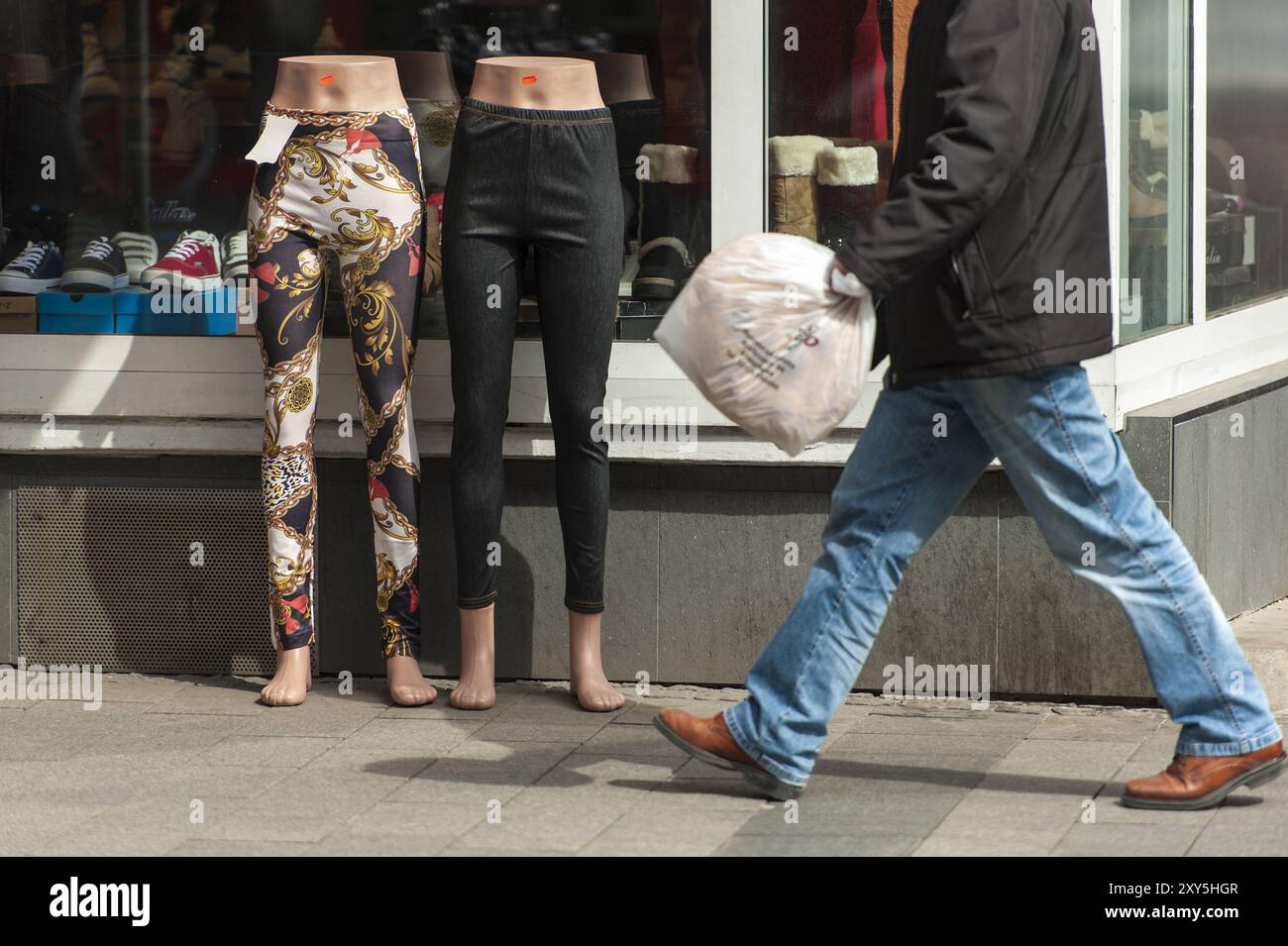 Headless passer-by with 2 halved mannequins Stock Photo - Alamy