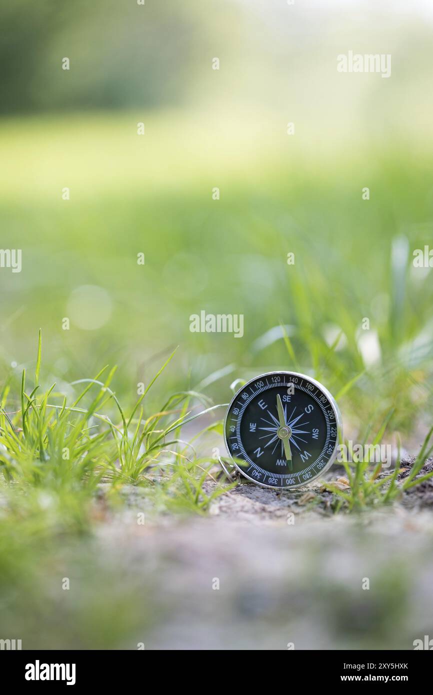 Vintage compass lying on the floor. Adventure and discovery concept ...