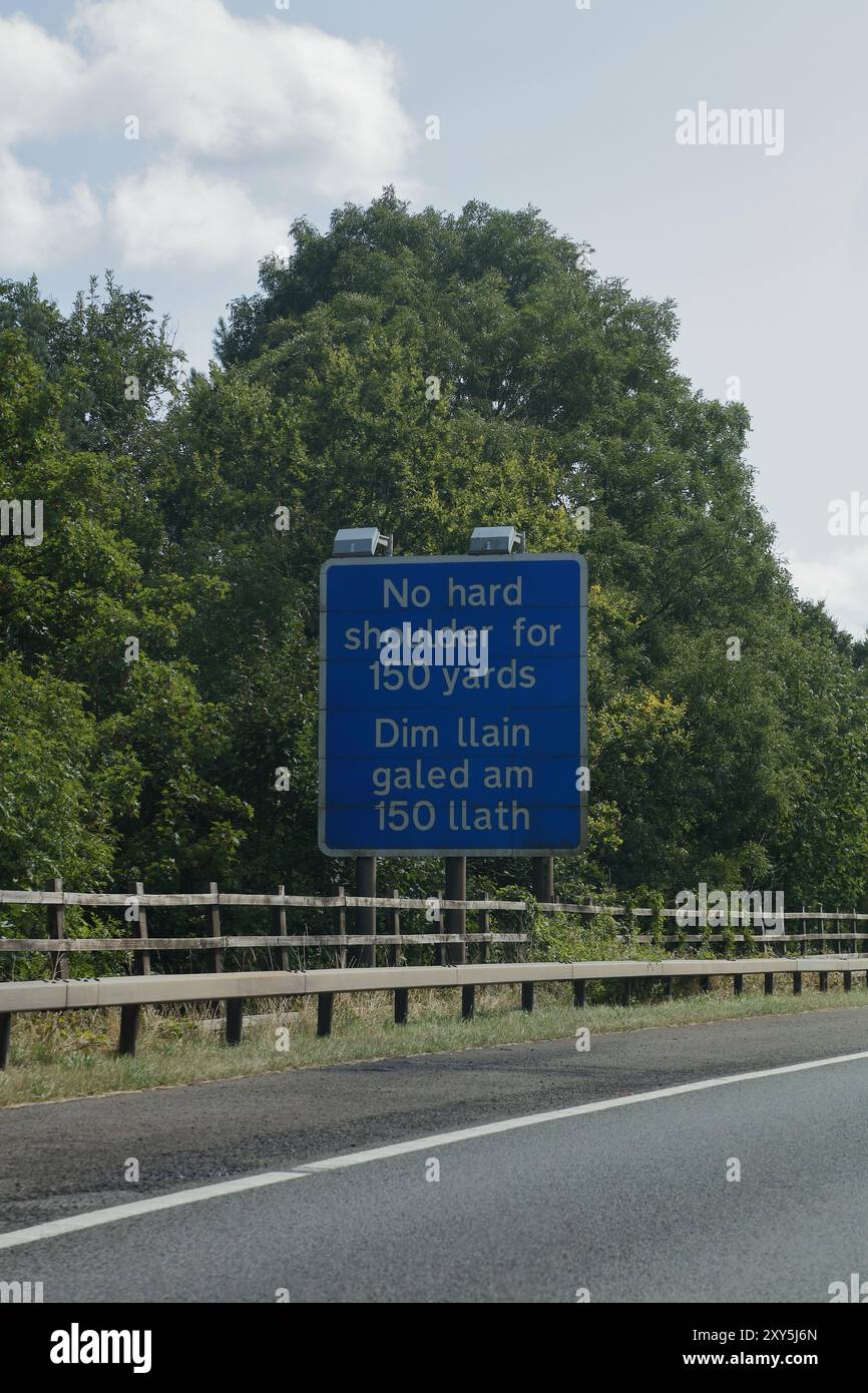 A large dual language sign warning drivers that the hard shoulder is ...