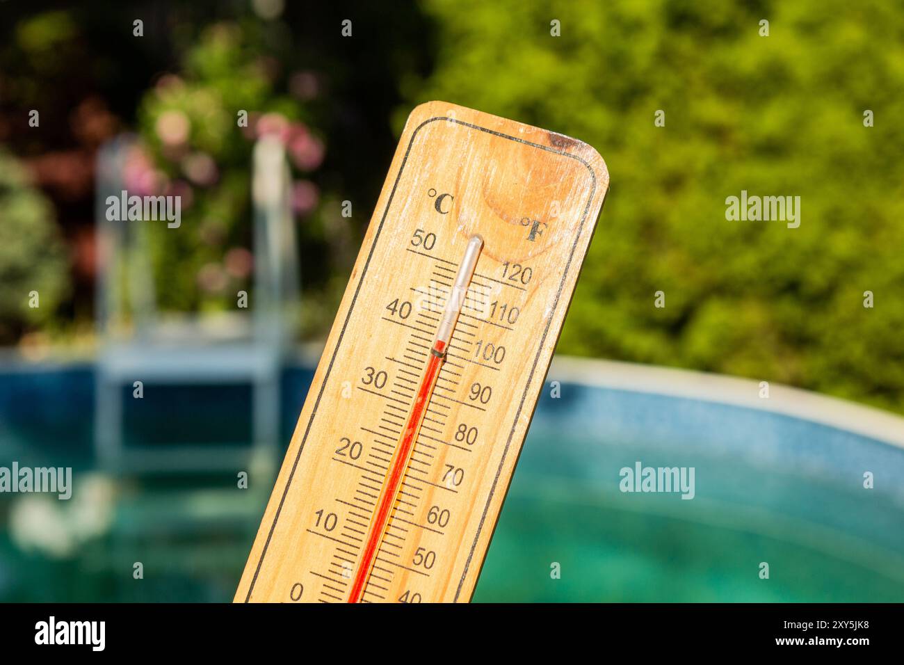 Thermometer displaying high summer temperature on a swimming pool ...