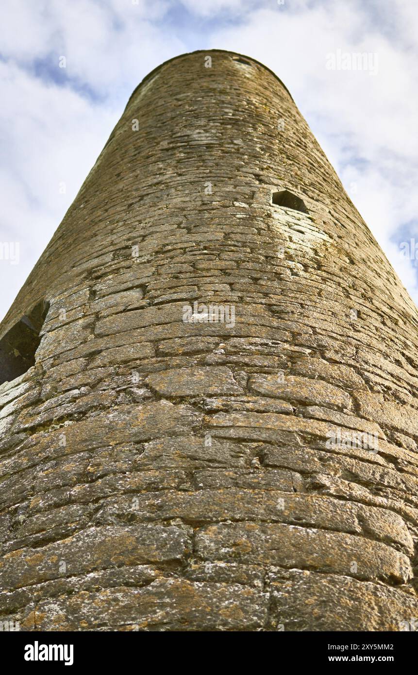 Medieval ruins of a temple build of limestone. Stone tower above place ...