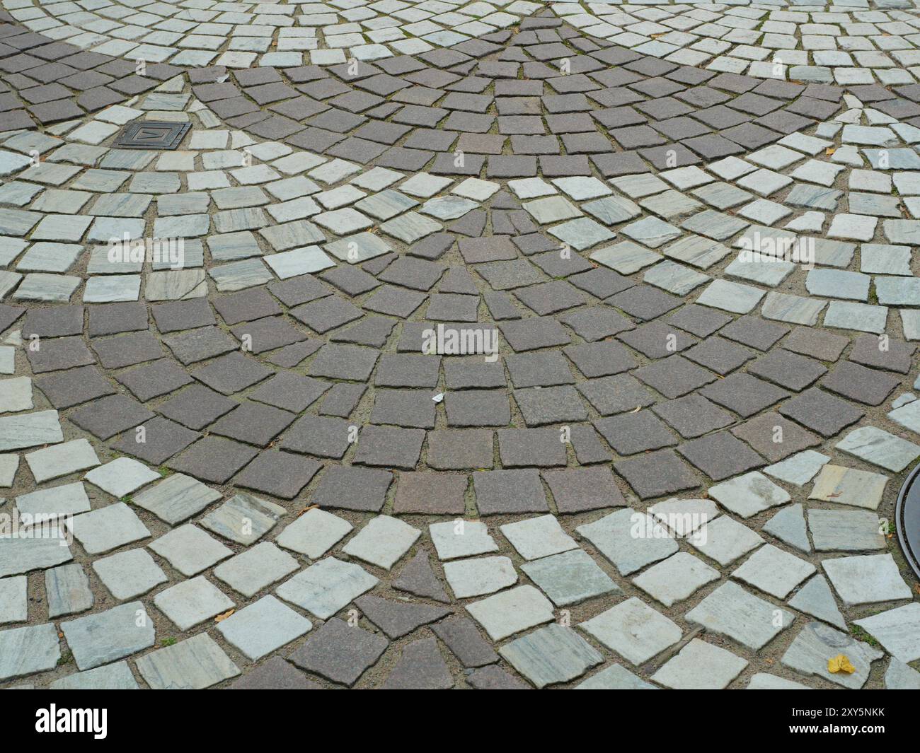 Two-tone, fan-shaped paving pattern with small granite cobblestones in ...