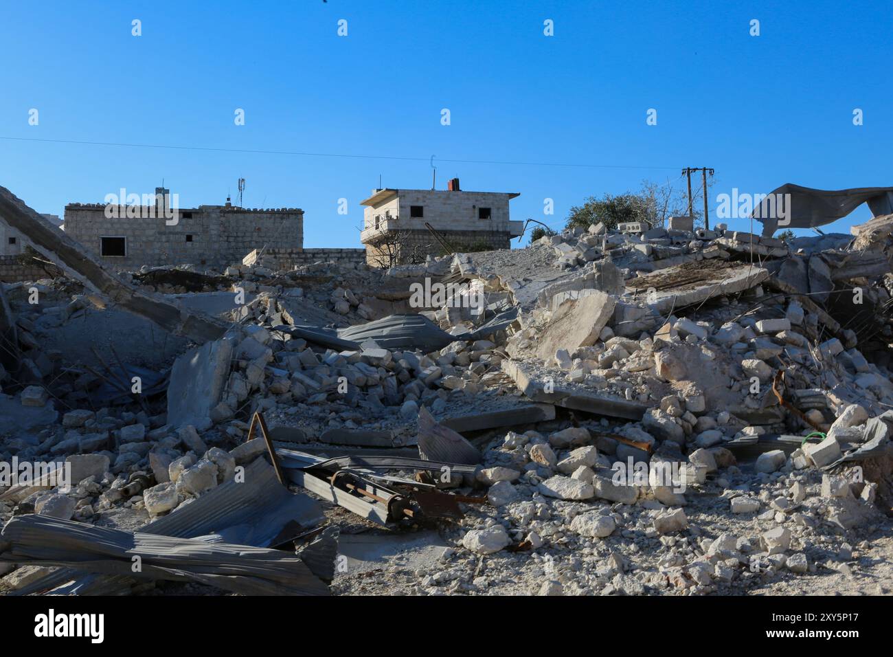 February. Severely damaged buildings in the village of Takad following ...