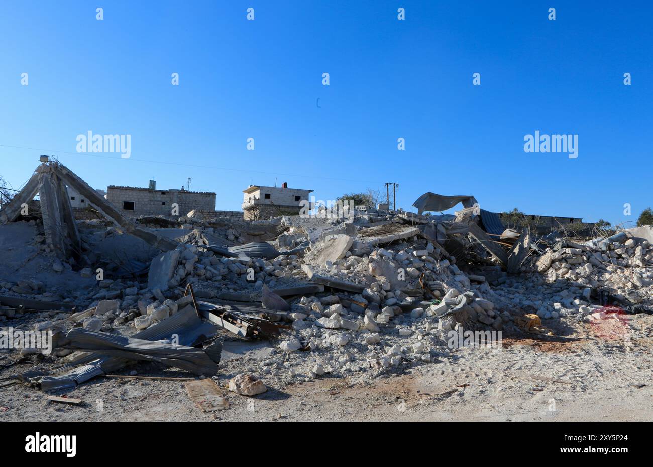 February. Severely damaged buildings in the village of Takad following ...