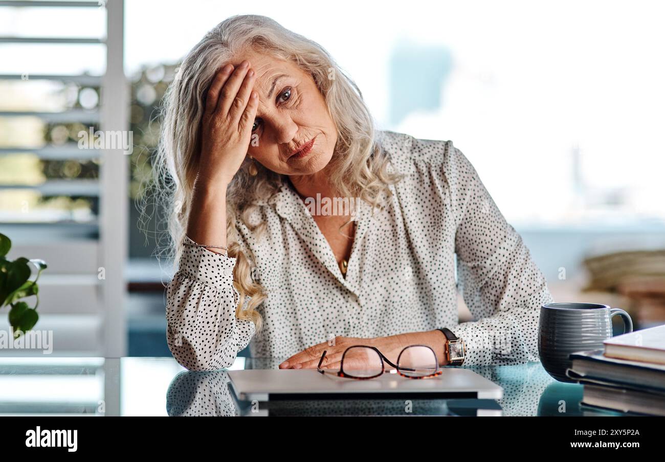 Mature woman, headache and thinking at desk for financial crisis ...