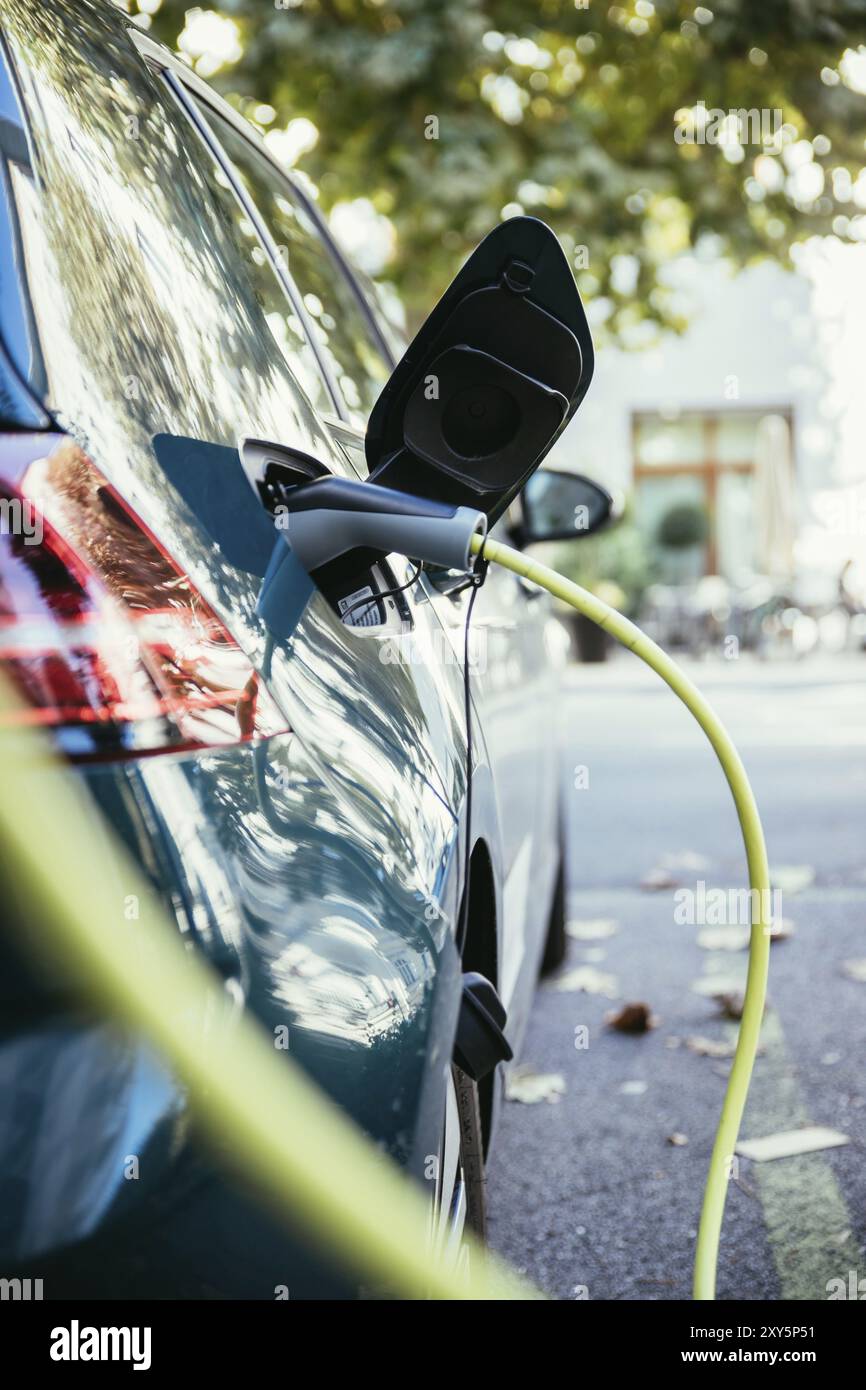 Electric car recharging with charge cable and plug leading to charge ...