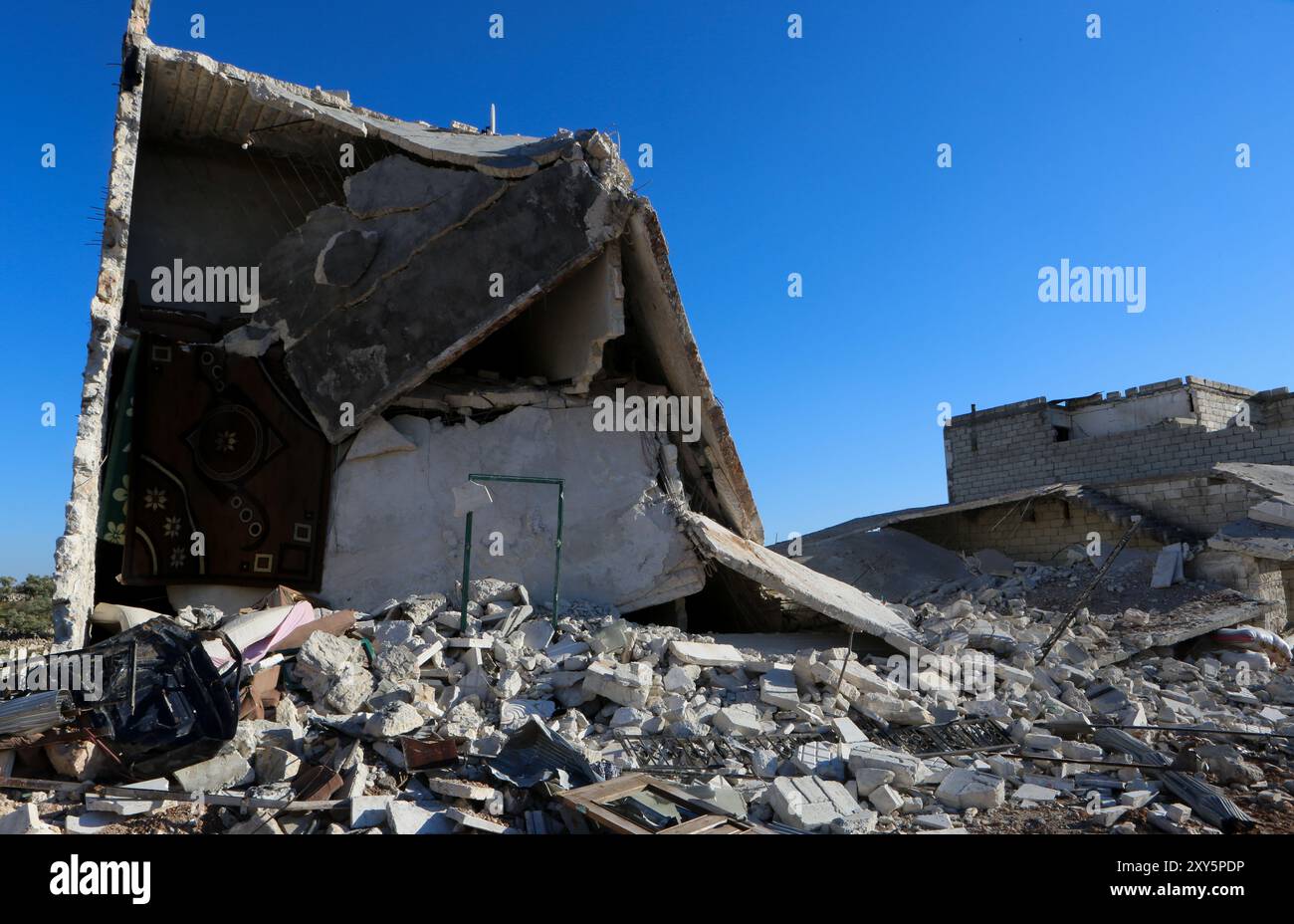 February. Severely damaged buildings in the village of Takad following ...