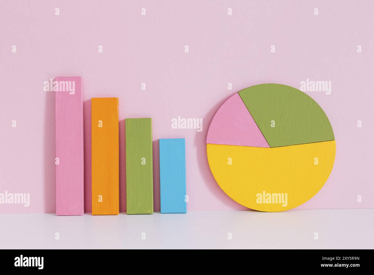 Colorful bar graph pie chart desk pink background. Beautiful photo ...