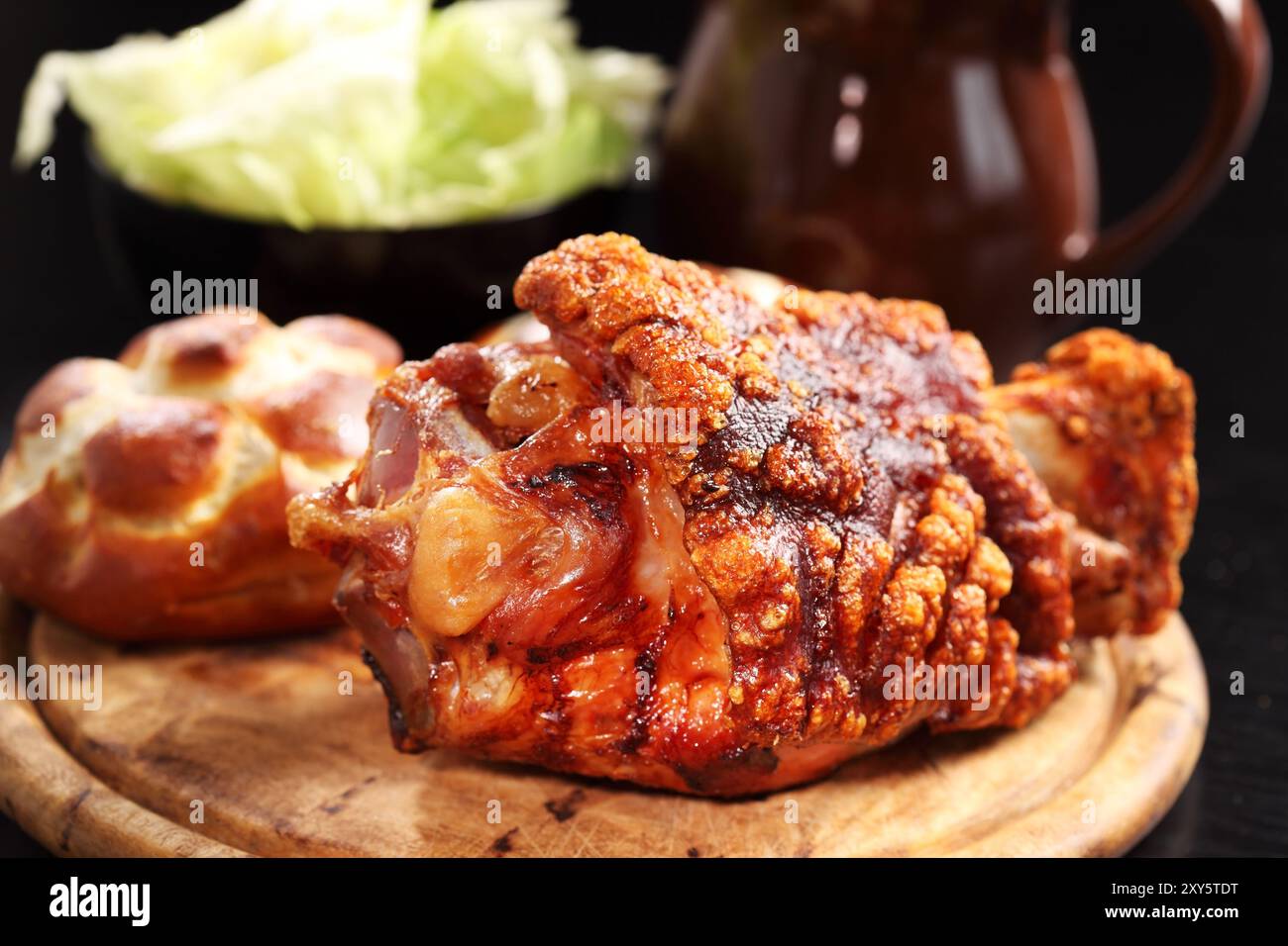 Grilled knuckle of pork with bread rolls and lettuce salad Stock Photo ...