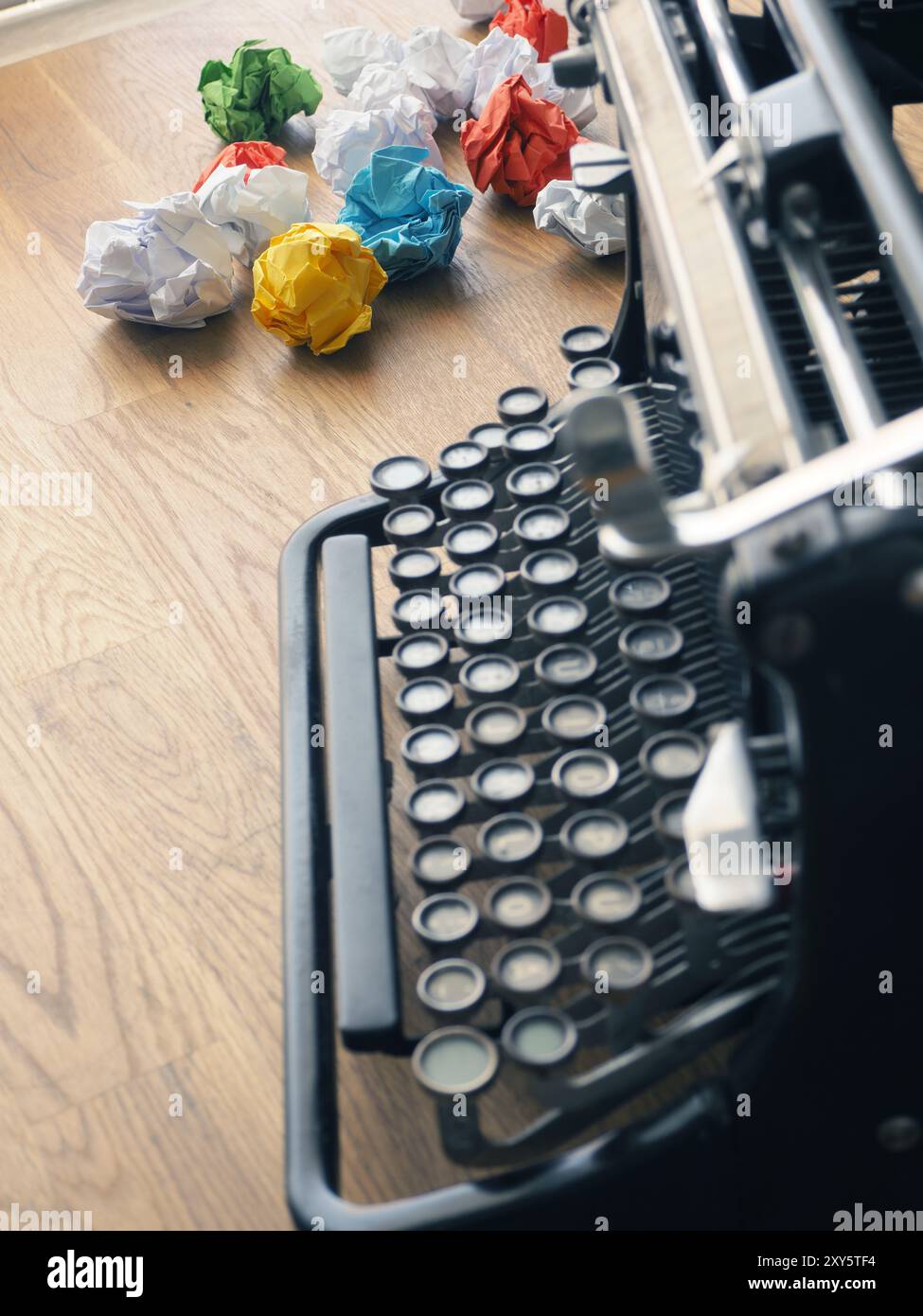 Crumpled paper with an old typewriter on a wooden office table ...