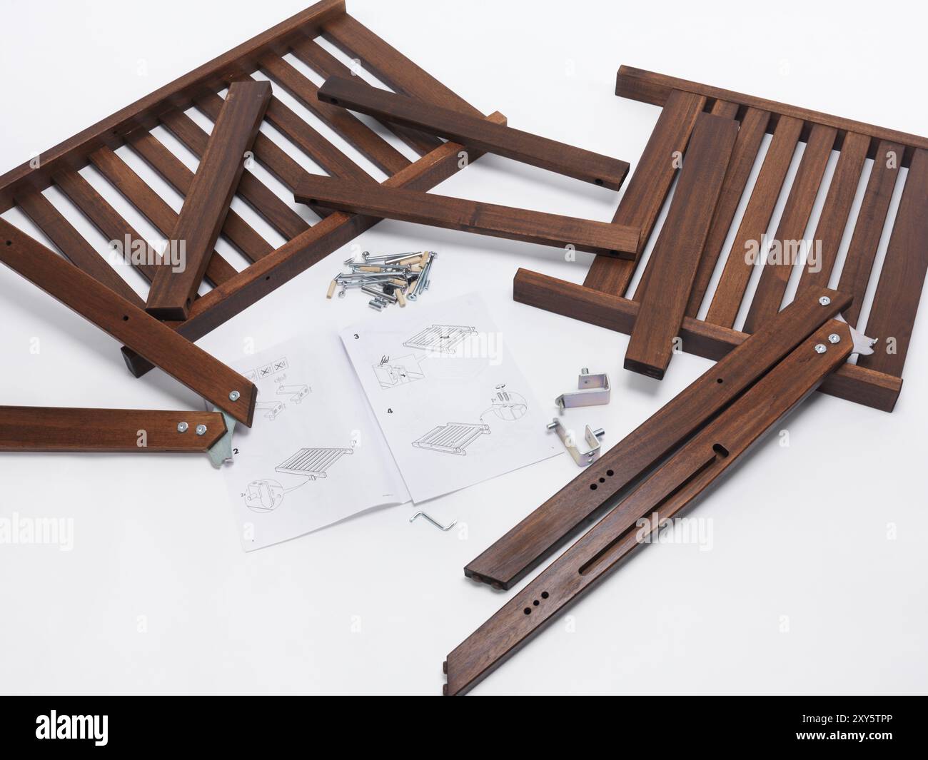 Assembling IKEA furniture parts with instructions Stock Photo - Alamy