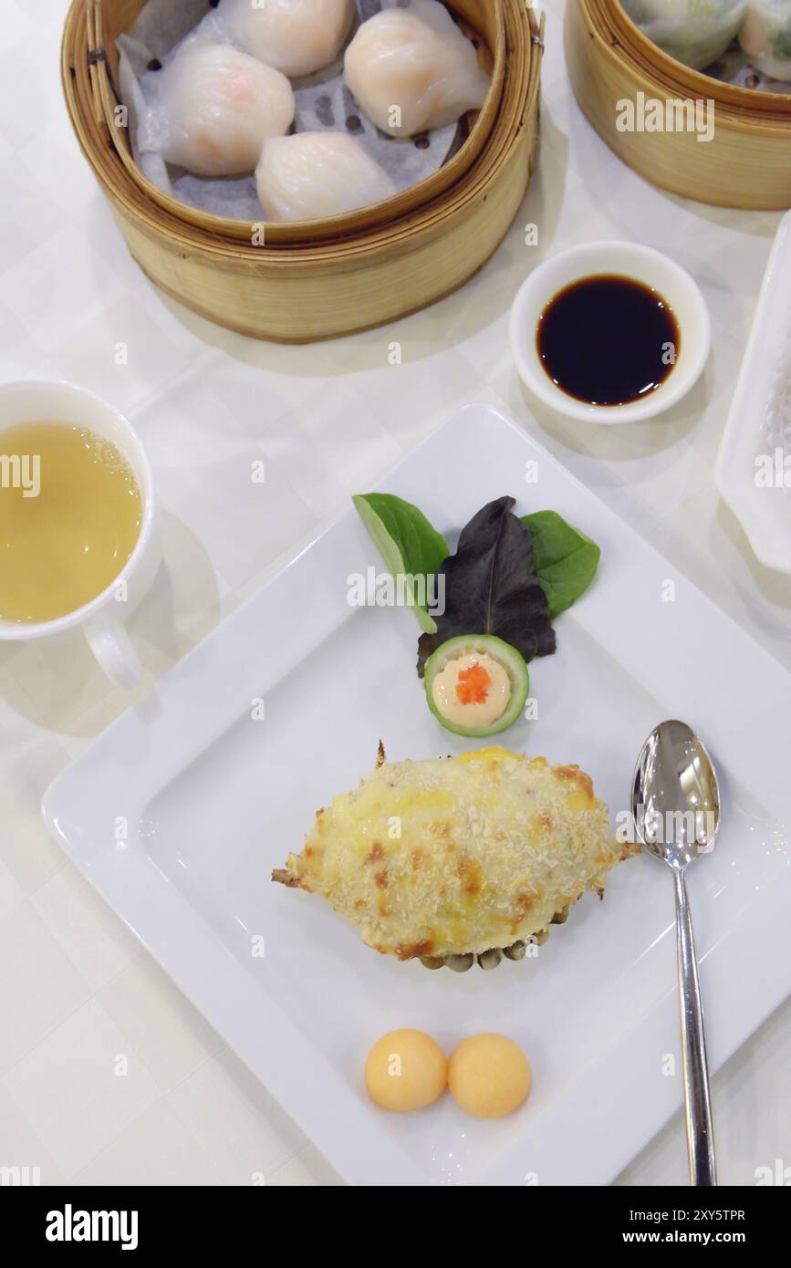 Crab meat stuffed crab shell and dim sum Chinese cuisine on a plate at ...