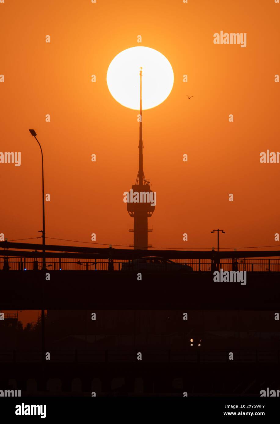 Sun sets behind Baghdad Tower and the Suspension Bridge in Baghdad ...
