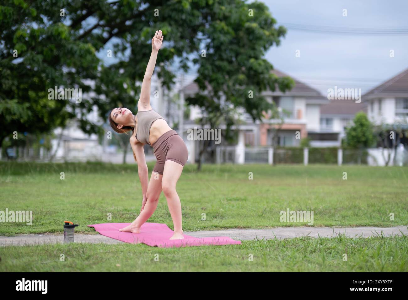 Woman in Triangle Pose During Outdoor Yoga Session Stock Photo - Alamy