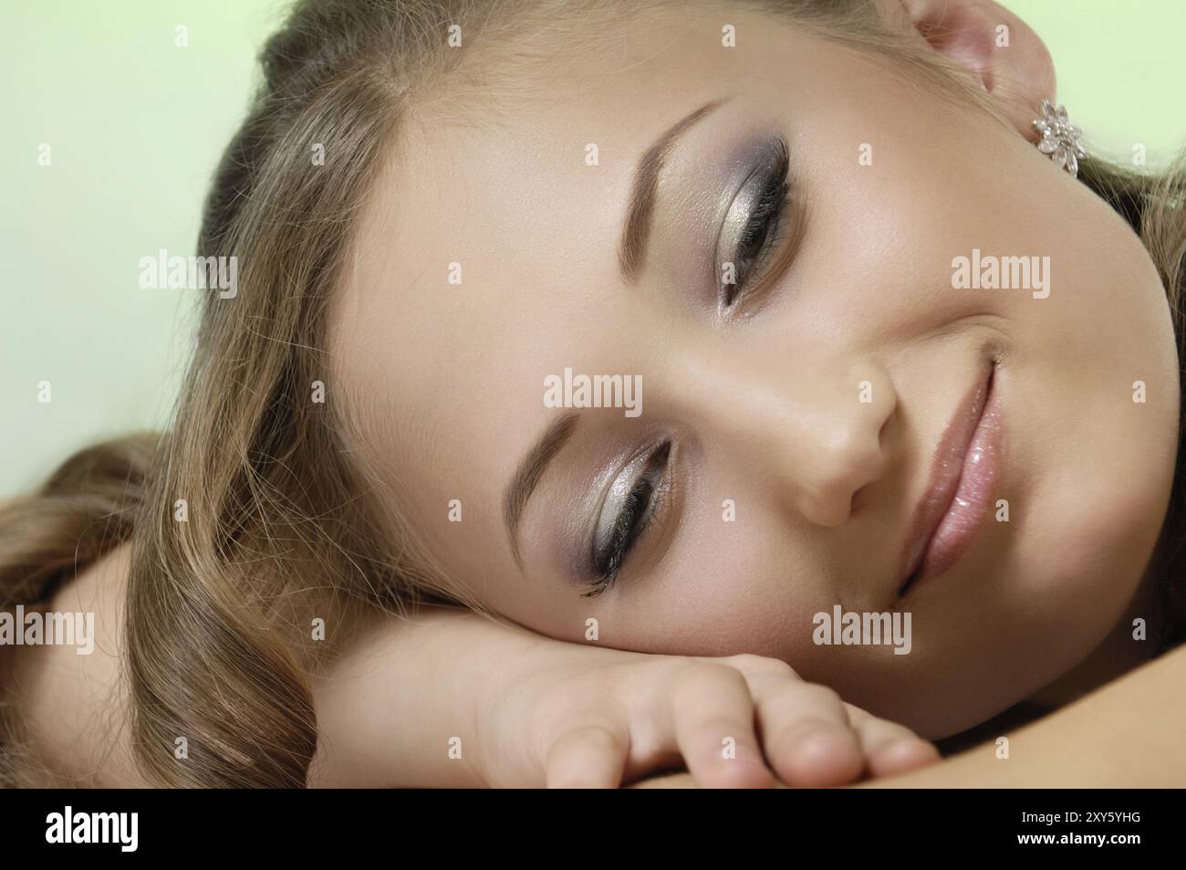 Smiling young woman face with dreamy expression, artistic close-up ...