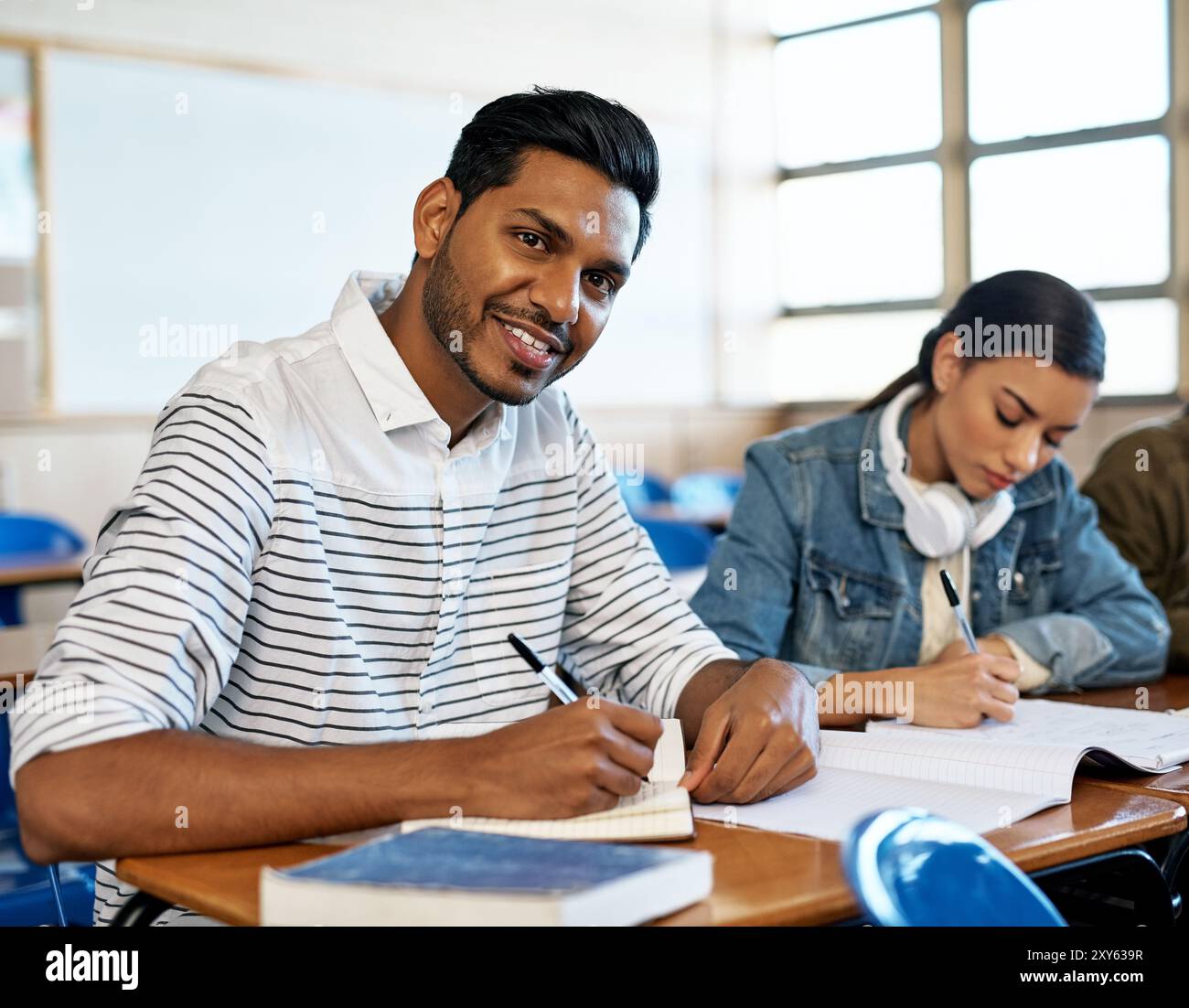 Education, university student and writing portrait in classroom for ...
