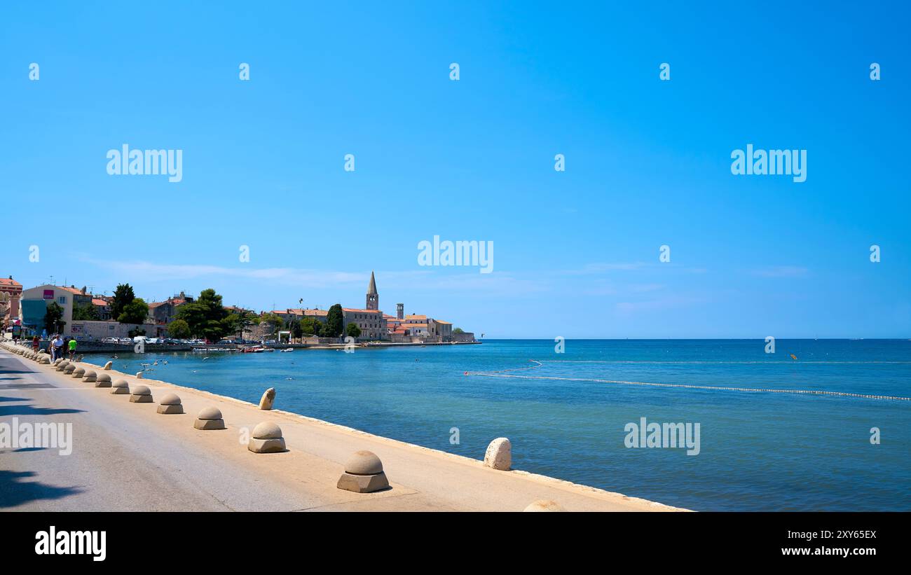 Waterfront promenade with the historic old town centre of Porec in ...