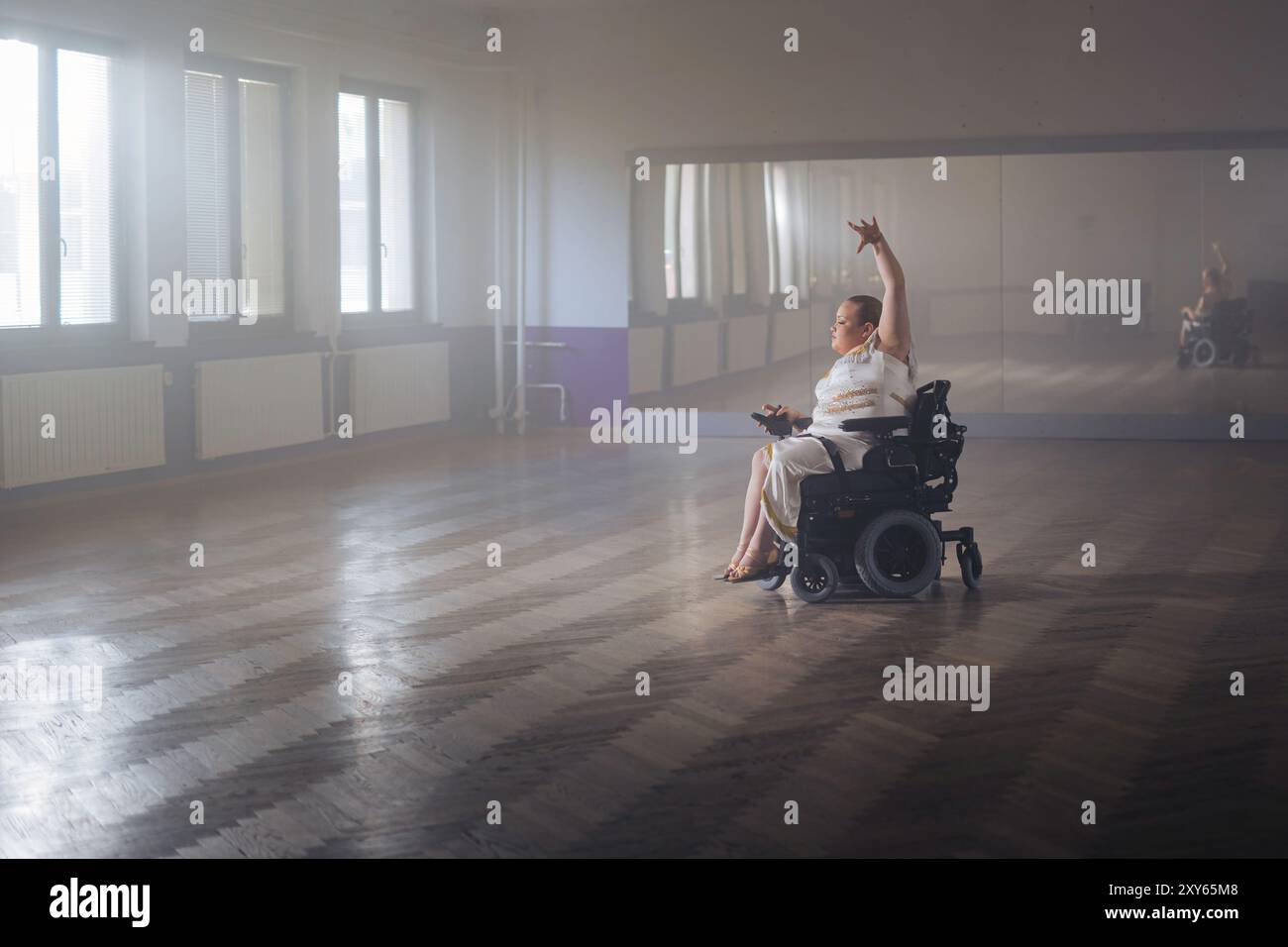Woman practicing and performing a freestyle wheelchair dance at a ...