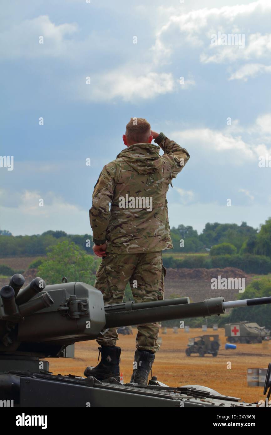 A soldier stop on top of a tank turret surveying the surroundings Stock ...