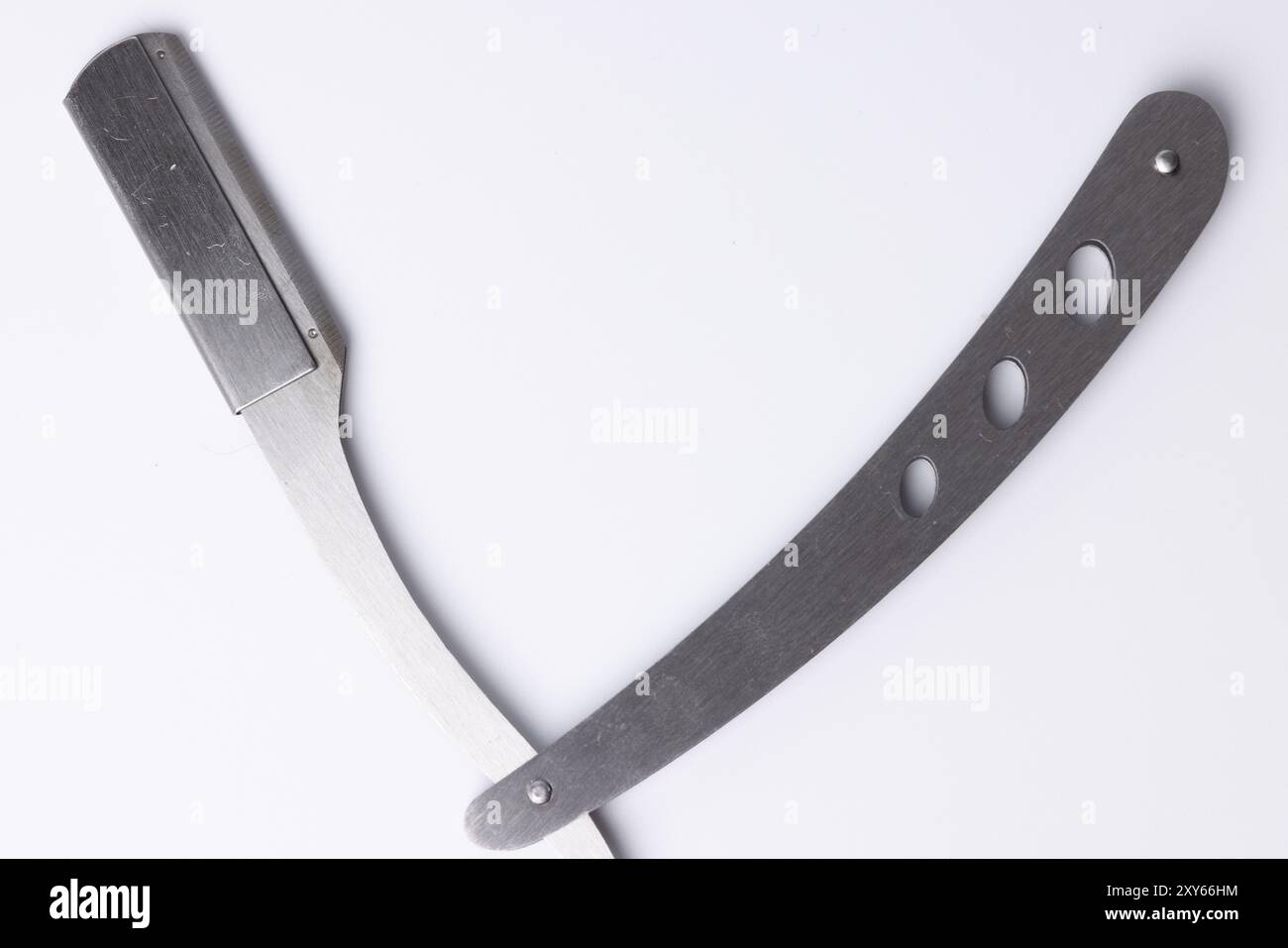 Detailed view of an open V-shaped barber razor, positioned centrally ...