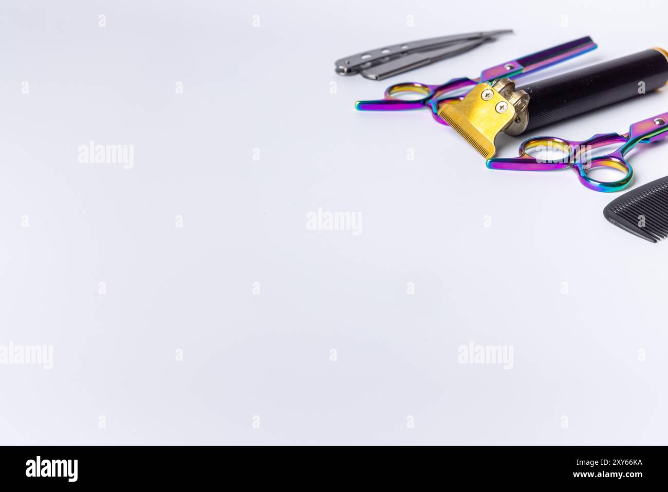 A clean, white background highlights a neat arrangement of barber tools ...