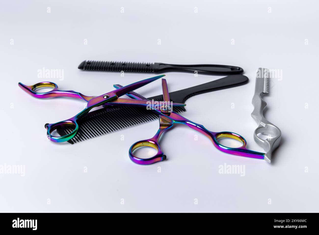 A collection of classic barber tools neatly arranged on a white ...