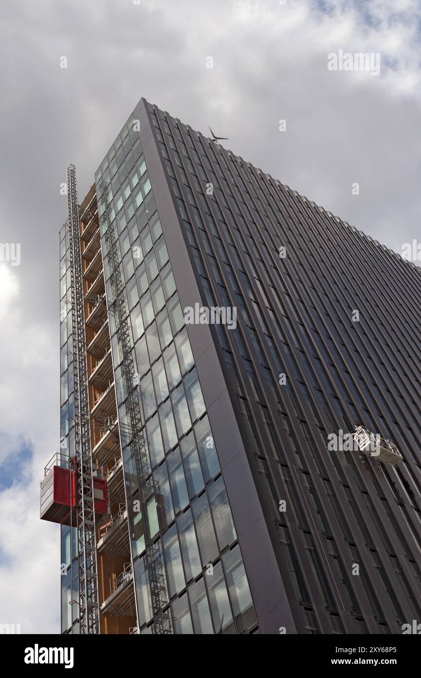 Material hoist and working platform on the facade of a high-rise ...