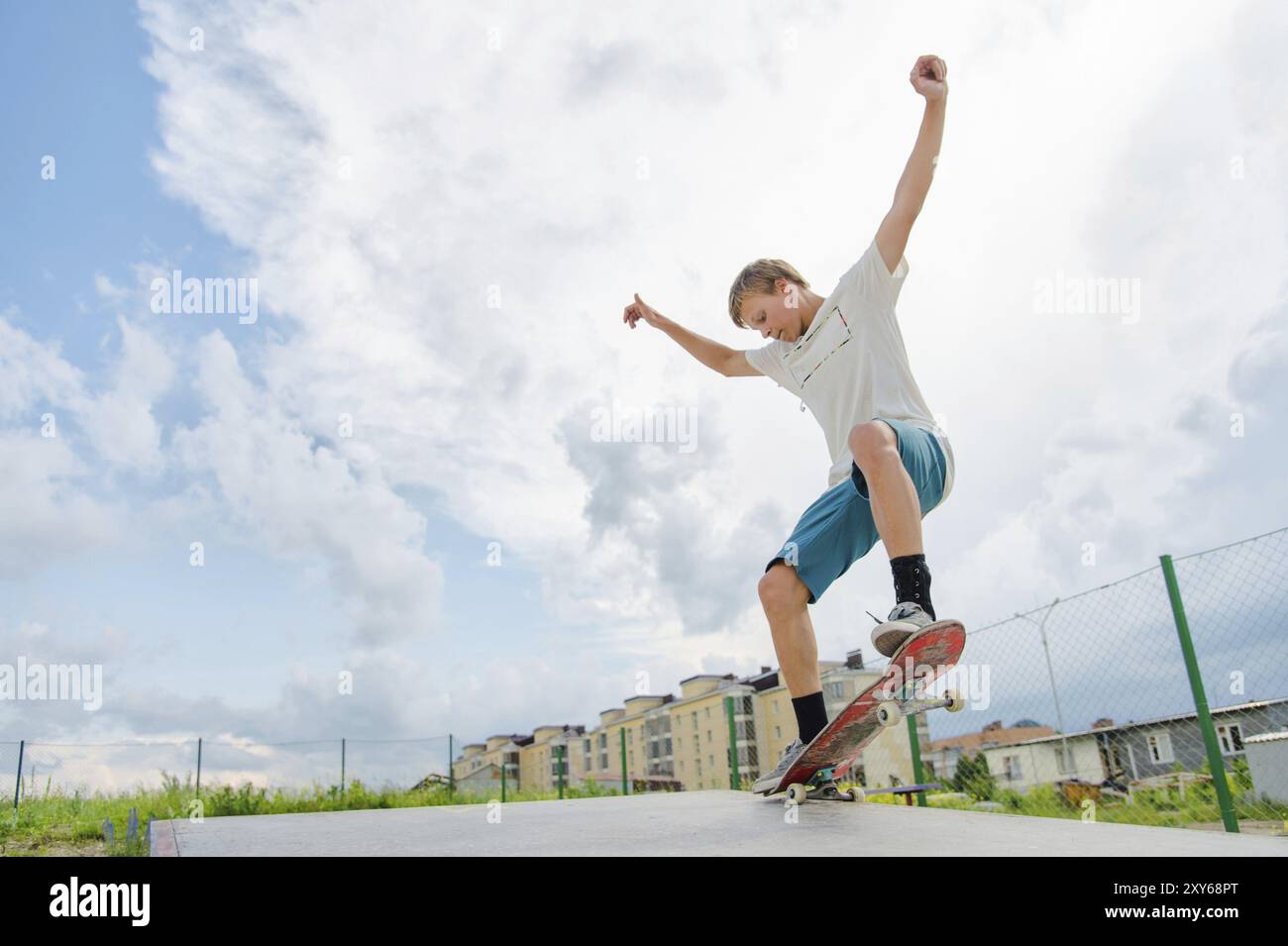 The boy skating catches the balance in the manual and slides on the ...