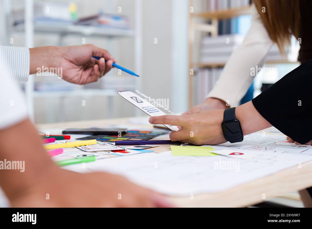 Creative Team Collaborating On Ux Ui Design Project With Wireframes And