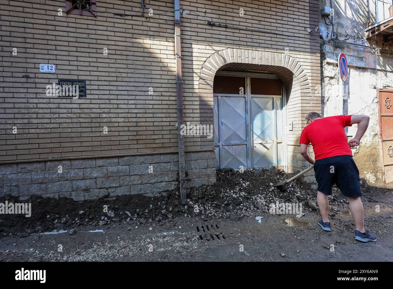 San Felice a Cancello, Italy, 28 August 2024. People shovel mud from ...