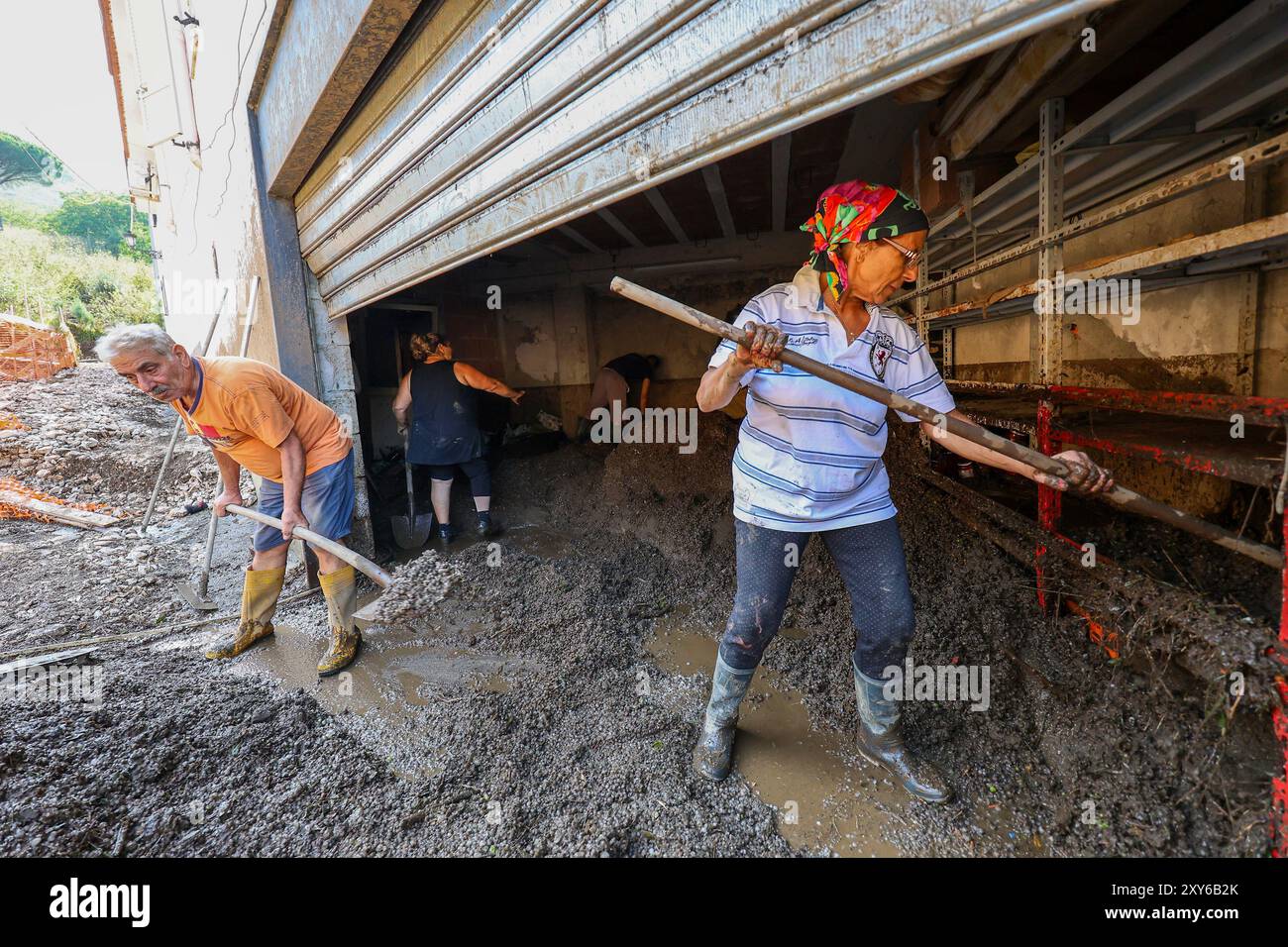 San Felice a Cancello, Italy, 28 August 2024. People shovel mud from ...