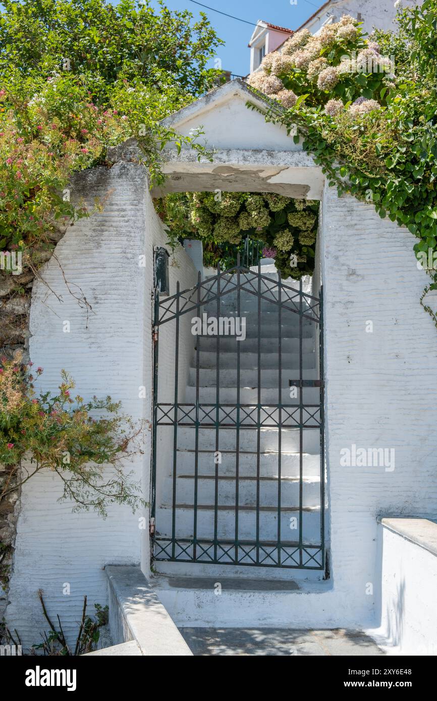 Greece. Closed metal gate, whitewashed stone stairs traditional house ...