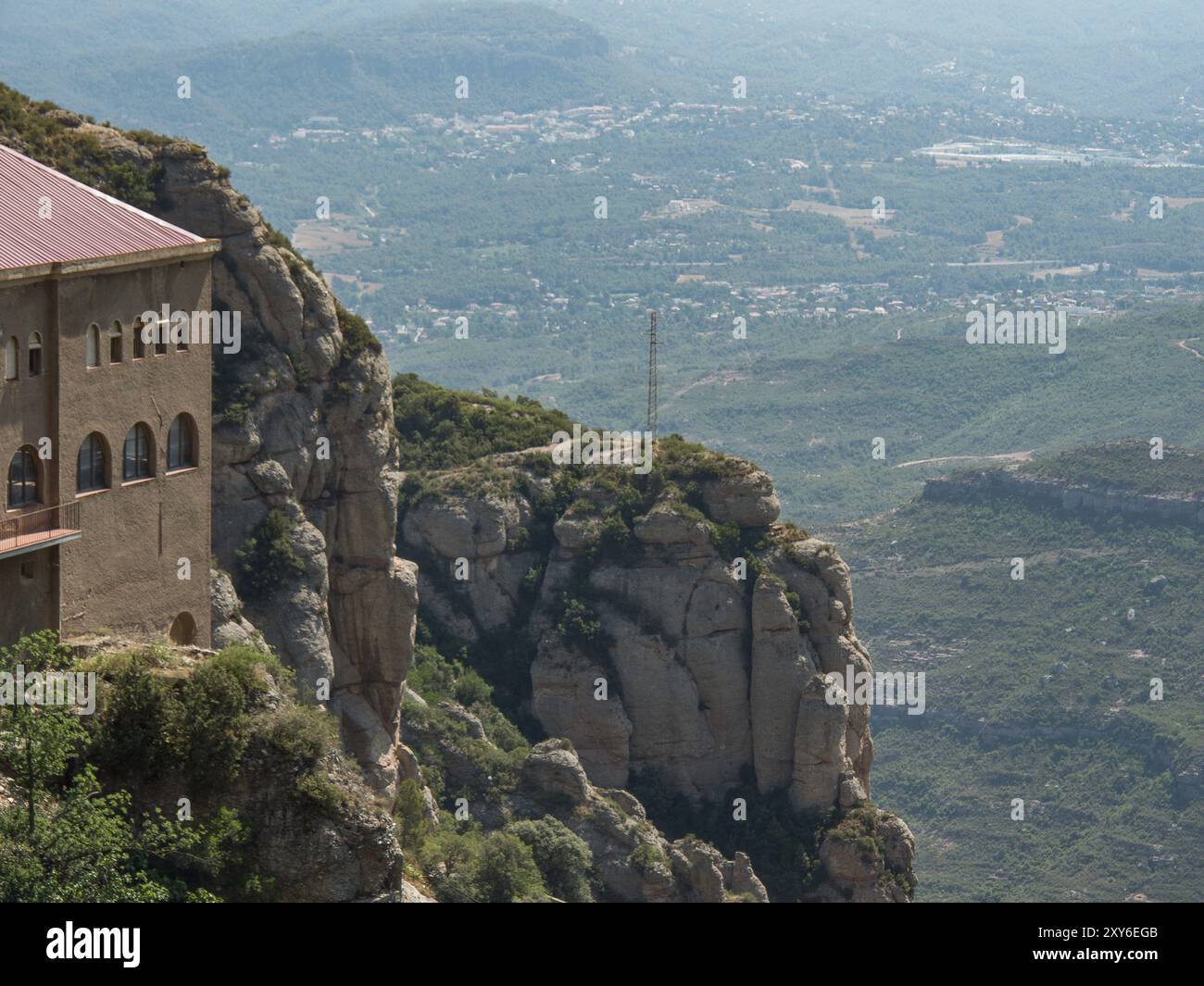 Building on a cliff overlooking the valley and the surrounding mountain ...