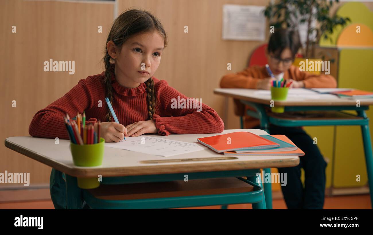 Concentrated Caucasian kid child schoolgirl primary school girl ...