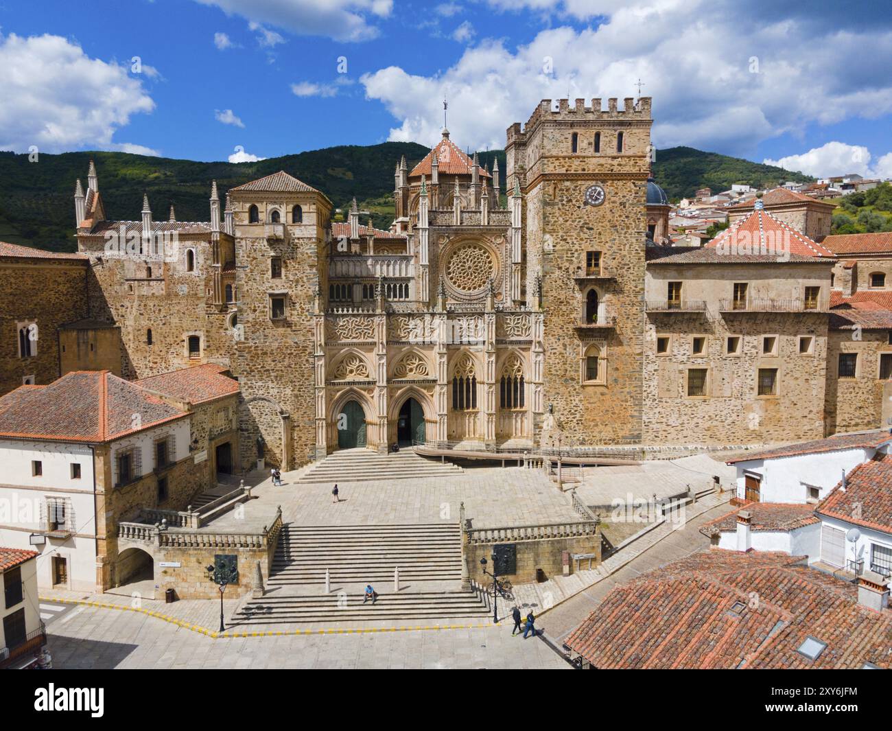 Aerial view of the facade of a monastery with red roofs and wide stairs ...