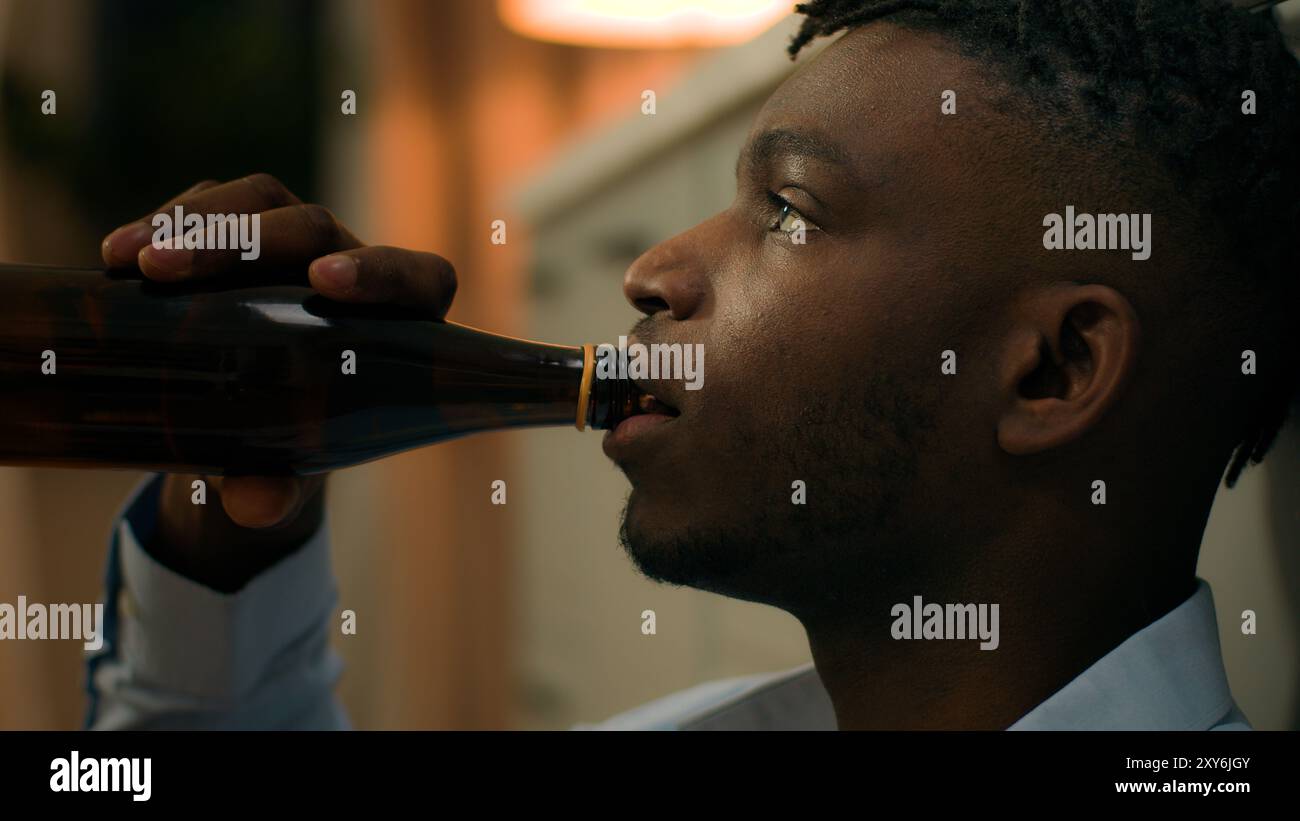 Addicted upset drunk African American depressed stress man drinking ...