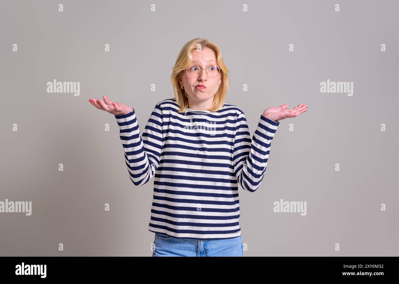 Confused businesswoman looking away and making face while shrugging ...