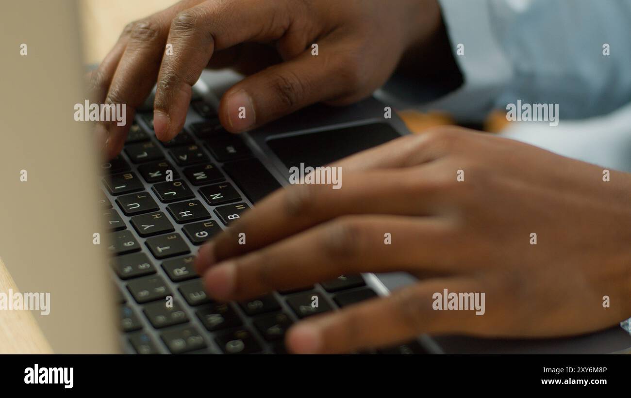 Unrecognizable biracial businessman student working studying with computer pc at table close up ...