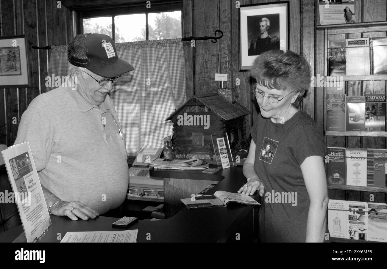 Curator showing brochures to a Caucasian woman at Andrew Jackson State ...