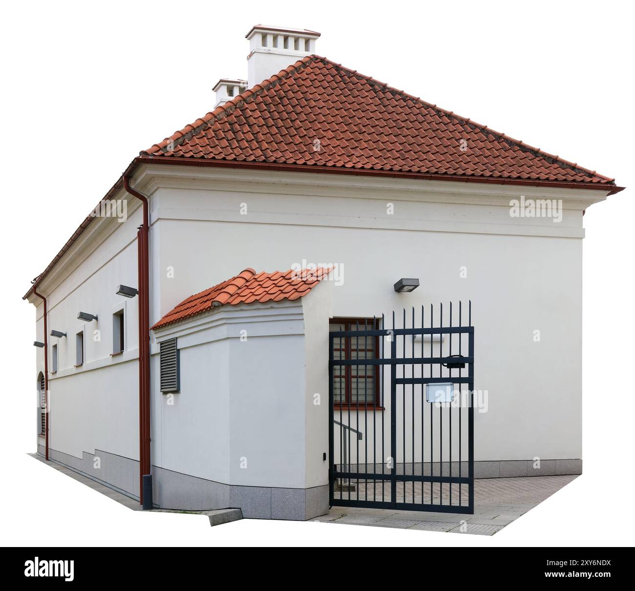 Ancient restored house with tiled red roof and iron gates. Isolated on ...
